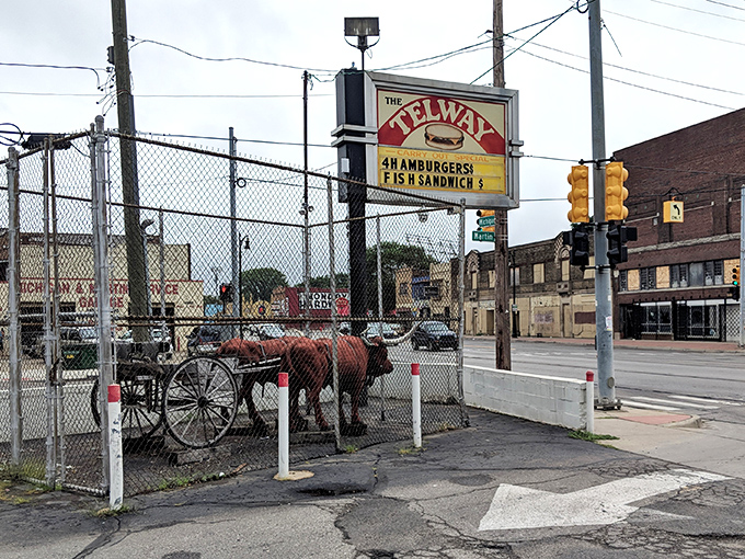 The iconic Telway sign stands as a beacon of hope for hungry travelers, promising "4 HAMBURGERS" like it's the answer to life's most pressing question.