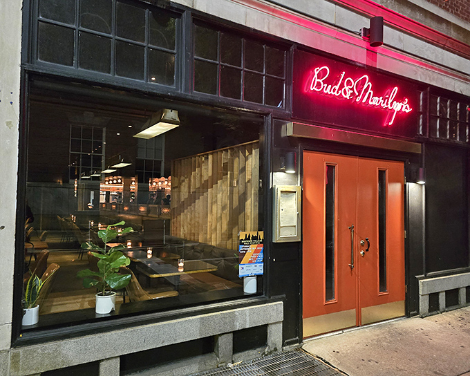 Those iconic red doors aren't just an entrance &ndash; they're a portal to comfort food paradise. Bud & Marilyn's neon sign glows like a beacon for hungry Philadelphians.