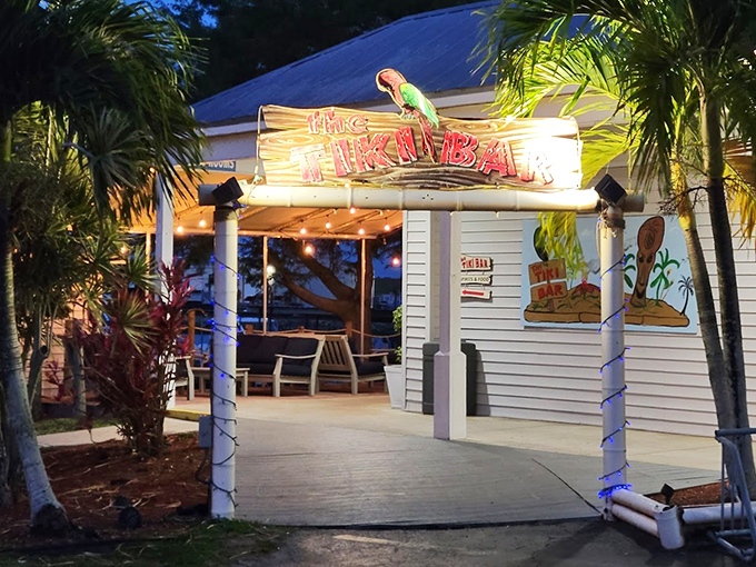 Paradise found! Scotty's Tiki Bar welcomes you with swaying palms and a sign that practically whispers, "Your vacation starts now."