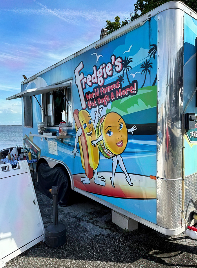 That cheerful blue food truck isn't just transportation &ndash; it's a mobile temple of hot dog happiness.