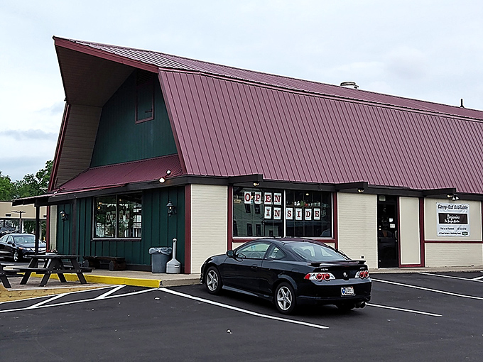 The distinctive A-frame green building with red trim stands like a culinary lighthouse beckoning hungry travelers to Dayton's hidden gem.