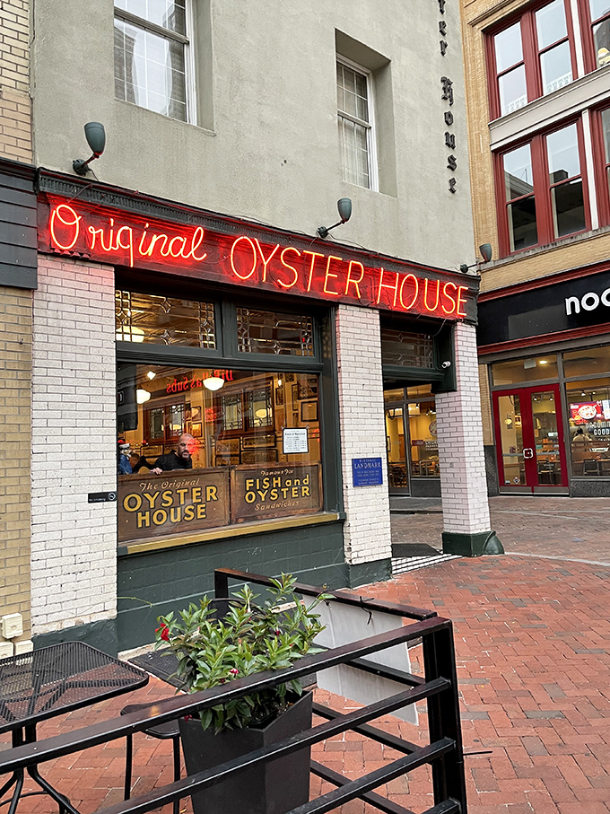 That iconic red neon sign beckons like an old friend, promising seafood treasures within these historic brick walls of Pittsburgh's Market Square.