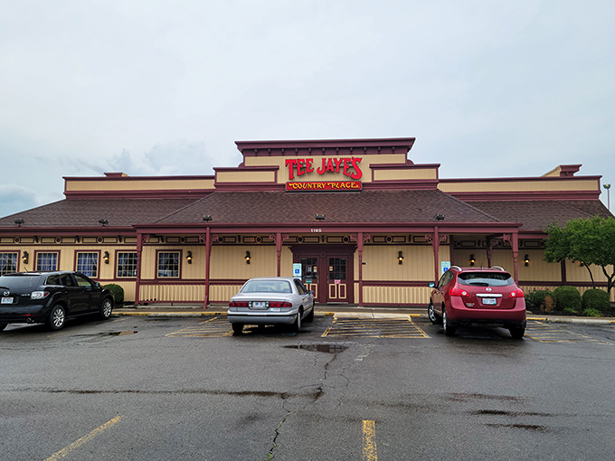 The red signage of Tee Jaye's stands out like a beacon of hope for hungry travelers. This unassuming exterior promises comfort food treasures within.