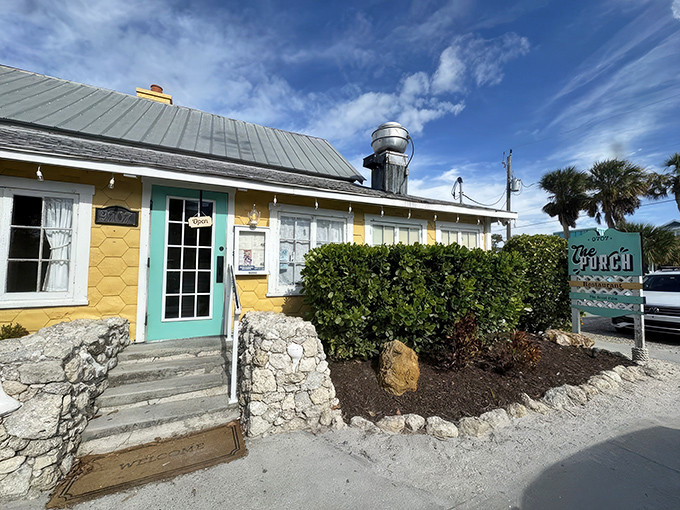 The sunny yellow exterior of The Porch Restaurant beckons like a cheerful neighbor who happens to be an exceptional cook. Those turquoise accents just scream "Florida vacation mode activated!"