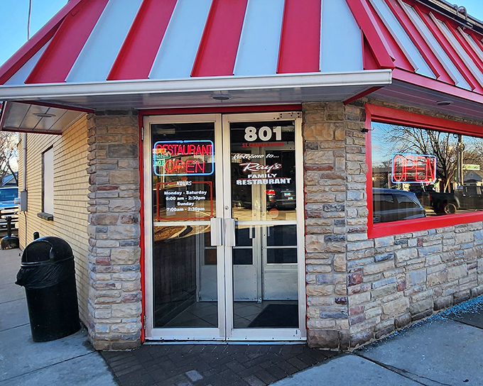The red and white awning of Ray's Diner beckons like a lighthouse for hungry souls navigating the streets of Elgin. Classic stone exterior promises timeless comfort within.