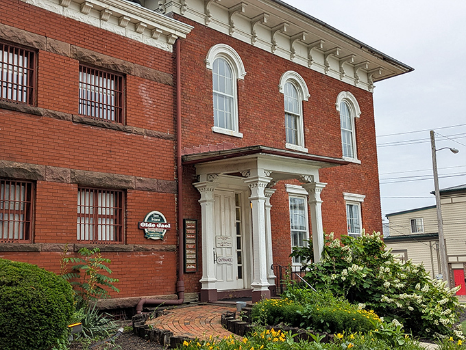 The historic brick exterior of Olde Jaol welcomes you with its weathered sign—proof that some of the best culinary experiences come with a side of character.