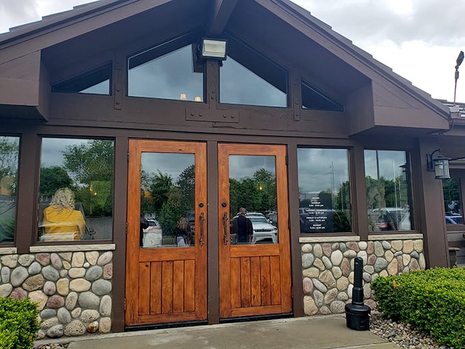 The rustic stone and timber exterior of Alibi of Troy beckons like a cozy northern Michigan lodge that somehow landed in the suburbs.