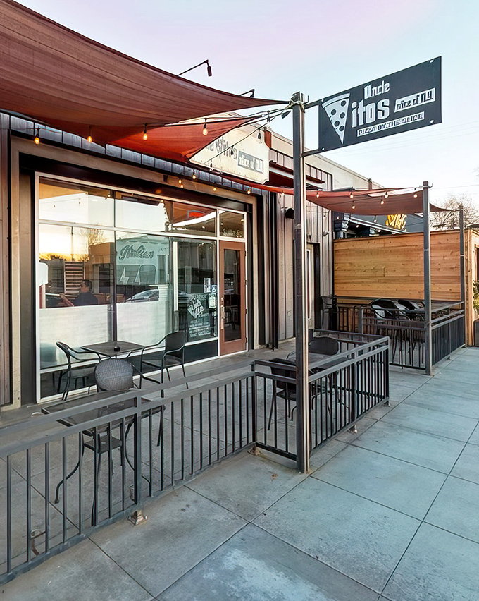 The perfect California-meets-New York moment: Uncle Vito's outdoor seating area, where Sacramento sunshine meets East Coast pizza tradition under those inviting red awnings.