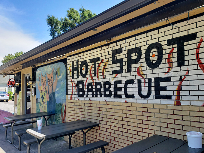 The unassuming yellow brick exterior of Hot Spot Barbecue is like a barbecue speakeasy &ndash; no fancy frills, just a white picket fence guarding smoky treasures within.