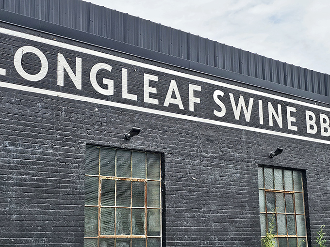 The sleek black brick exterior of Longleaf Swine announces itself with understated confidence, like a barbecue joint that knows it doesn't need to shout.