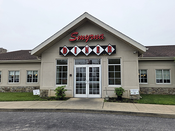 The iconic red Smyrna Diner sign beckons hungry travelers like a lighthouse for the famished. Delaware's answer to comfort food paradise awaits behind those doors.