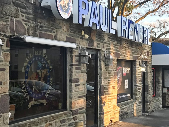 The stone fortress of flavor! Paul Revere Pizza House's iconic exterior stands as a Delaware County landmark, its blue lettering a beacon for hungry pizza pilgrims.