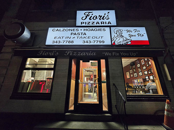 The modest storefront glows like a beacon in the night, promising salvation for the hungry with its straightforward motto: "We Fix You Up."