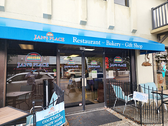 The bright blue awning of Jan's Place beckons like a lighthouse for hungry souls navigating the streets of Jensen Beach.