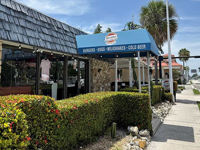 The unassuming blue awning of Brooks Burgers beckons from downtown Naples, promising simple pleasures that outshine their fancy neighbors.