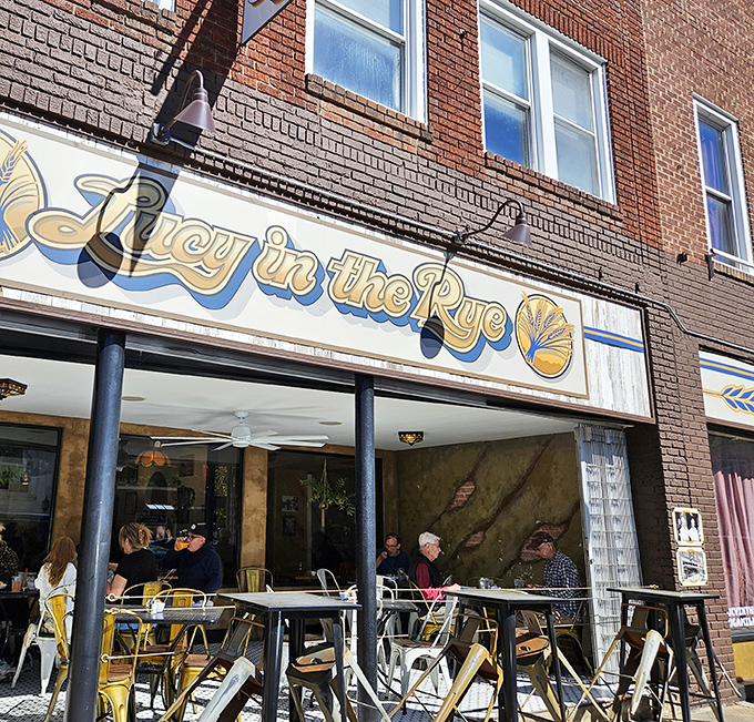 The storefront beckons like an old friend on Sylva's Main Street, with its cheerful blue and gold signage promising comfort and community inside.