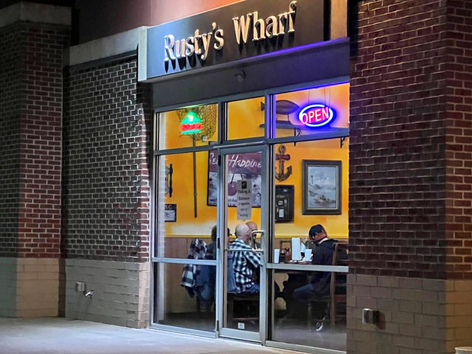 Rusty's Wharf glows like a maritime beacon in suburban Ohio, its bright yellow walls and neon "OPEN" sign promising seafood salvation to landlocked locals.