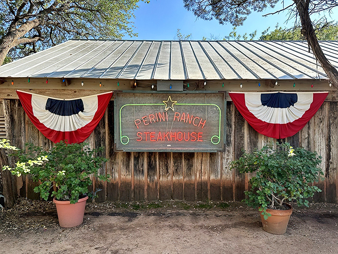 The unassuming entrance to culinary greatness. Weathered wood, colorful string lights, and that iconic sign promising mesquite-grilled perfection in Buffalo Gap.