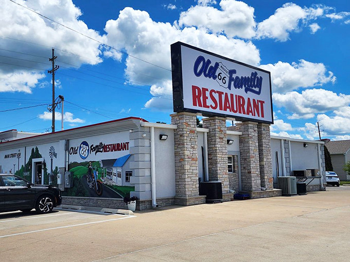 The iconic Route 66 shield beckons hungry travelers like a lighthouse for the famished. This white stone exterior with patriotic murals promises authentic Americana inside.