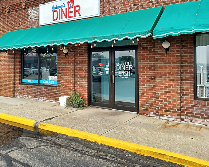 Johnny's Diner announces itself with understated charm &ndash; a brick facade, green awnings, and the promise of comfort food that'll make your day infinitely better.