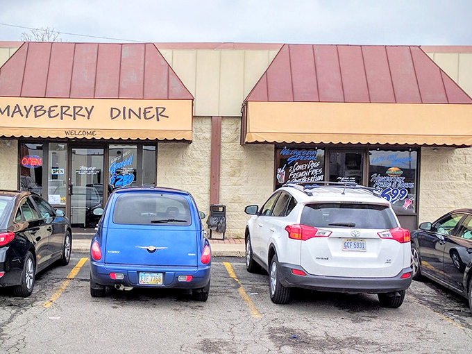 The modest exterior of Mayberry Diner belies the culinary treasures within. Those red awnings have sheltered generations of hungry Toledoans seeking comfort food paradise.
