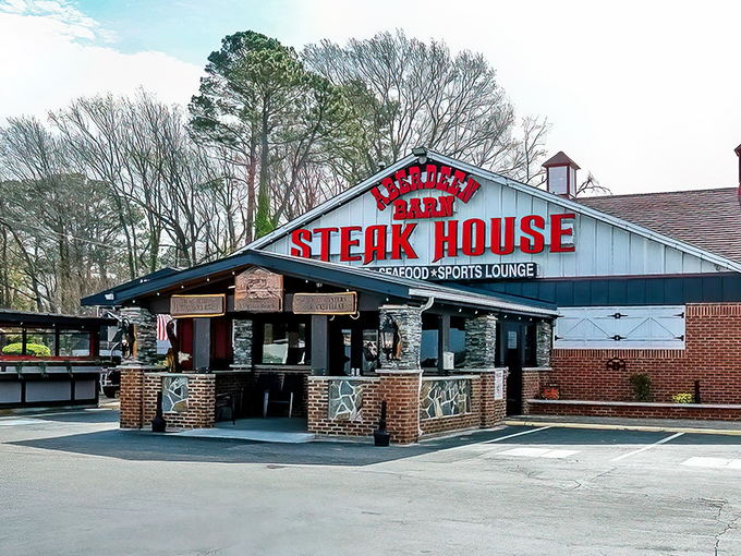 The iconic blue barn with bold red lettering announces your arrival at meat paradise. No trendy minimalism here&mdash;just the promise of serious steak.