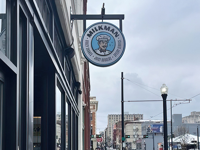 Milkman's sleek storefront beckons like a modern-day burger beacon, promising delicious treasures behind those gleaming black-framed windows.