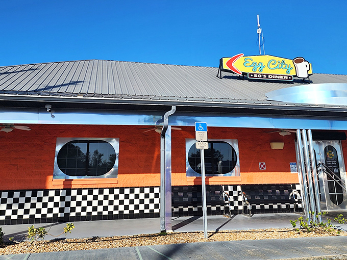 The vibrant orange exterior with classic black-and-white checkerboard trim isn't just eye-catching&mdash;it's practically sending breakfast smoke signals to hungry travelers on the highway.