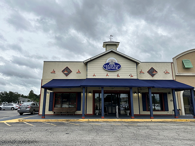 The classic cream exterior with navy blue awnings of Broadway Diner stands like a beacon of breakfast hope in Bartow, promising comfort food salvation inside.