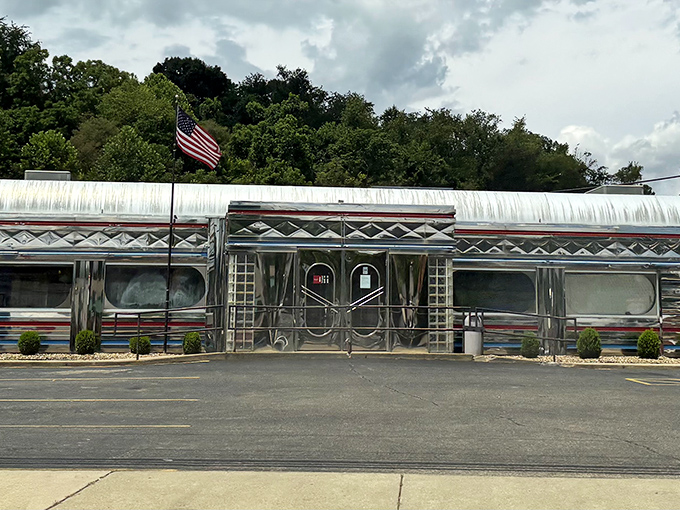 The gleaming stainless steel exterior of Diner 23 stands like a time capsule on wheels, permanently parked in Waverly with an American flag proudly waving hello.