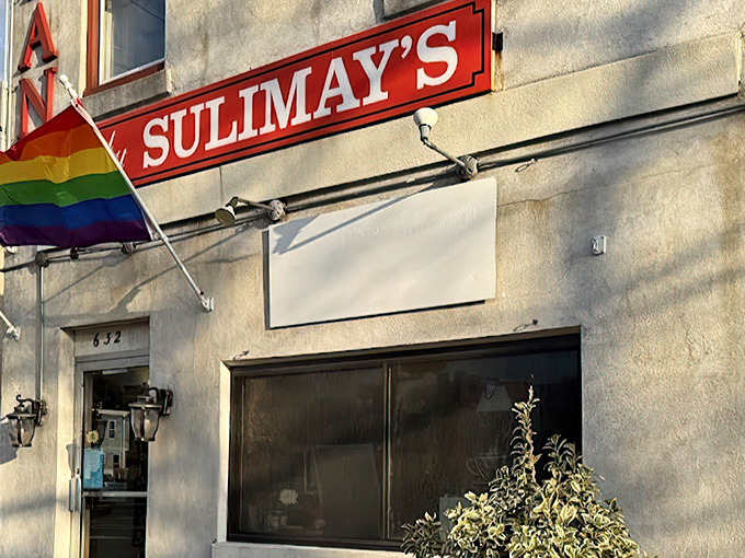 Sulimay's exterior welcomes you with old-school charm and a rainbow flag, promising both tradition and inclusivity in this Fishtown cornerstone.
