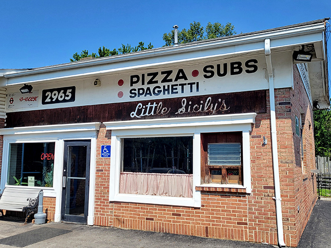 The unassuming brick exterior of Little Sicily's might not scream "culinary destination," but those pink curtains whisper, "Come in, we've got the good stuff."