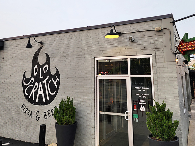 The unassuming gray exterior of Old Scratch Pizza belies the flavor revolution happening inside. Like a culinary speakeasy, it keeps its superpowers hidden in plain sight.