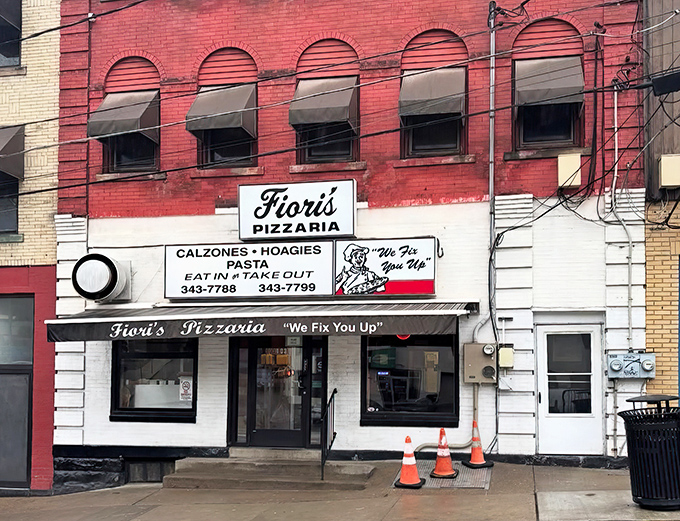 The brick facade of Fiori's Pizzaria stands like a culinary lighthouse on Brookline Boulevard, its iconic "We Fix You Up" promise beckoning hungry Pittsburghers for generations.