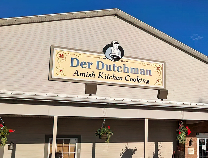 The welcoming porch of Der Dutchman stands like a beacon of comfort food promise in Walnut Creek, where hanging flower baskets greet hungry travelers.