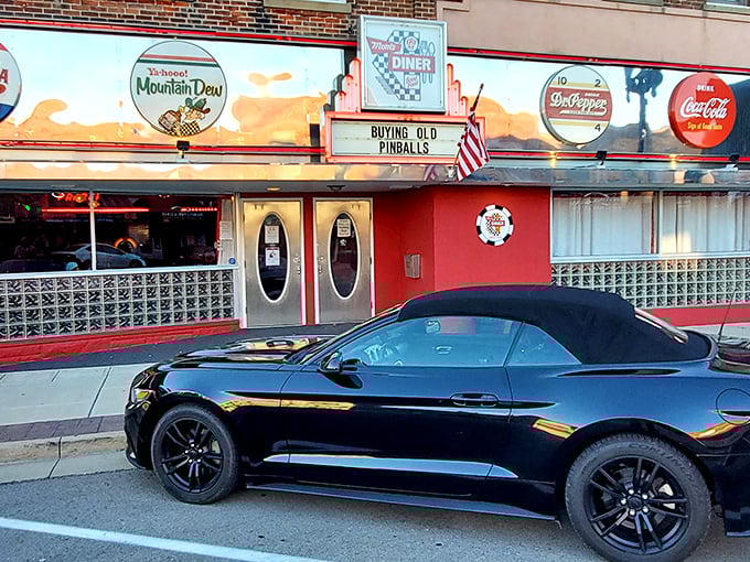 The vibrant red exterior of Mom's Diner & Pizzeria stands out like a beacon of nostalgia, complete with those iconic oval doors straight from American Graffiti.