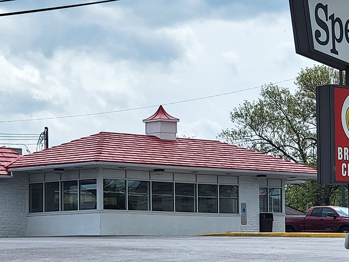 The iconic red-roofed Speck's Drive-In stands like a time capsule of Americana, promising simple pleasures and culinary nostalgia to all who visit.