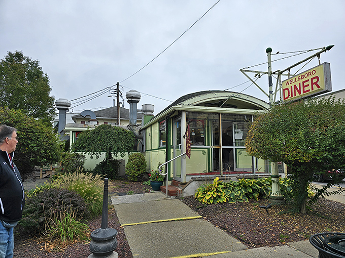 The iconic barrel-roofed Wellsboro Diner stands like a time capsule on Main Street, its vintage sign promising comfort food and nostalgia in equal measure.
