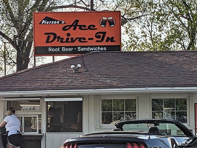 The iconic orange sign of Pierson's Ace Drive-In stands as a beacon of nostalgia in Joliet, promising root beer and sandwiches that have stood the test of time.