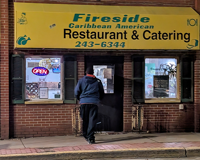 The bright yellow awning of Fireside Caribbean beckons like a tropical sun in Pittsburgh's urban landscape. Caribbean paradise awaits inside!