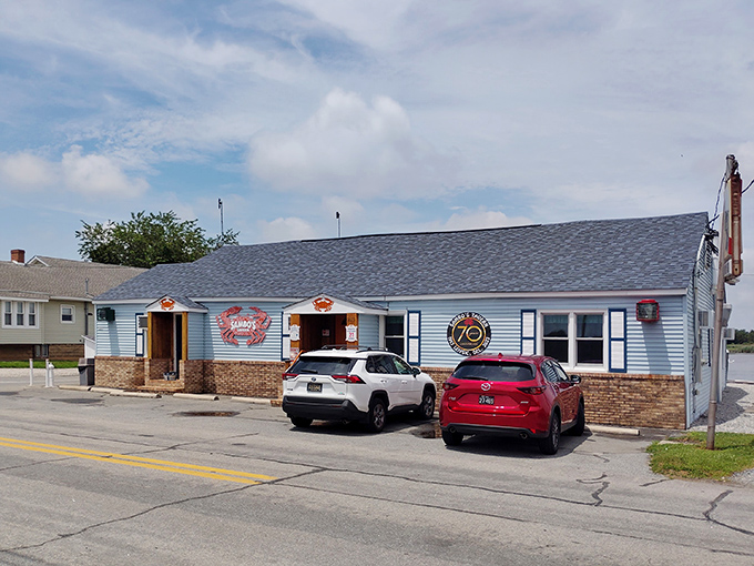 The iconic blue exterior of Sambo's Tavern, where those giant red crab signs aren't just decoration&mdash;they're a delicious promise of what awaits inside.