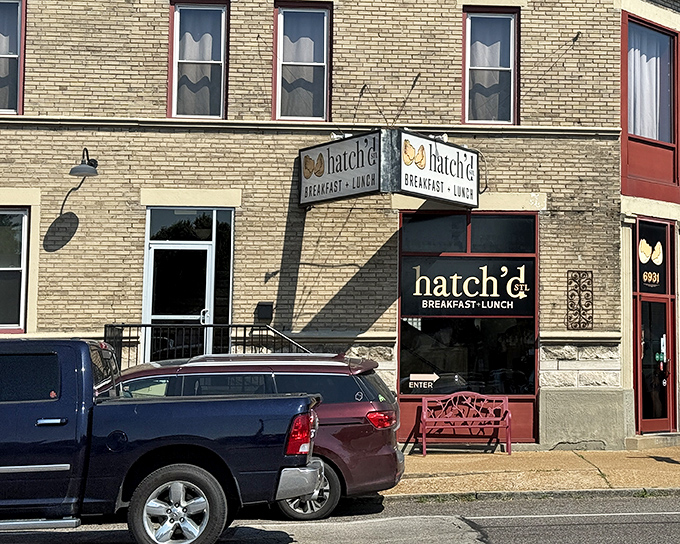 The iconic Hatch'd STL storefront beckons with its charming red bench and cracked egg logo&mdash;like a breakfast beacon in St. Louis brick.