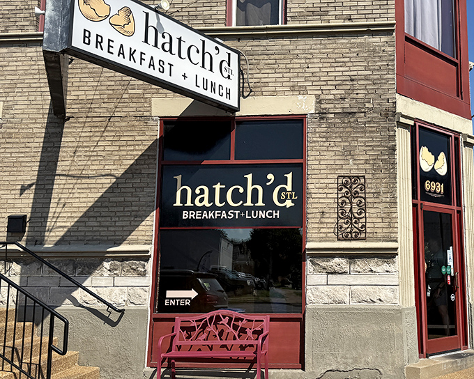The iconic Hatch'd STL storefront beckons with its charming red bench and cracked egg logo&mdash;like a breakfast beacon in St. Louis brick.