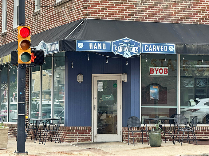 The blue storefront with its "HAND CARVED SANDWICHES" awning is like Clark Kent's glasses &ndash; a humble disguise for sandwich superhero powers within.