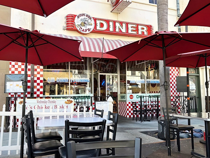 The classic red and white checkered facade of Busy Bee Cafe beckons like a time portal to simpler days when diners ruled American roadways.