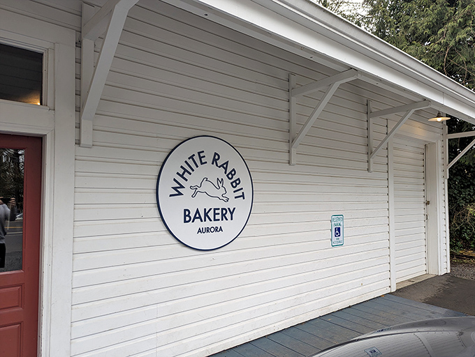 The unassuming exterior of White Rabbit Bakery beckons like a secret clubhouse for carb enthusiasts. That red door might as well be a portal to pastry paradise.