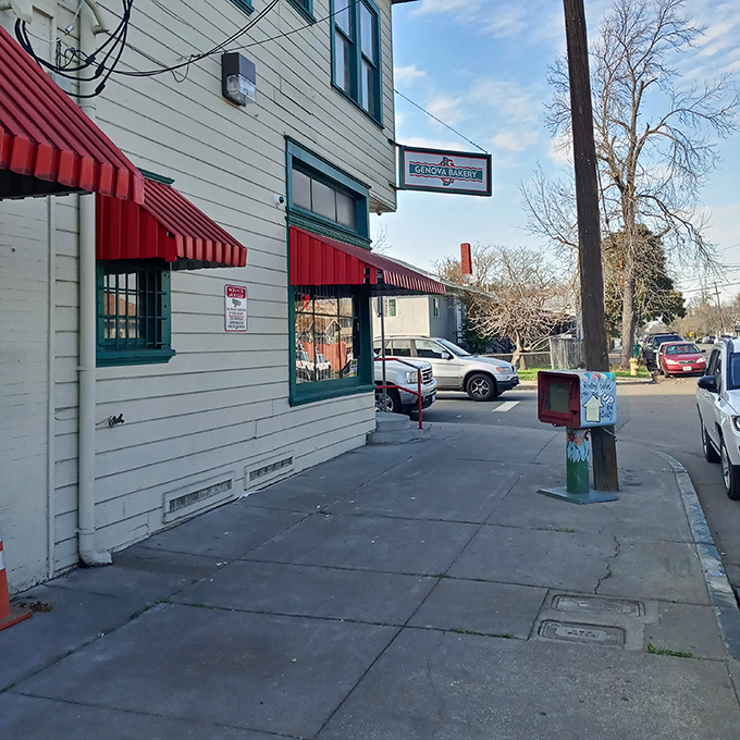 The cream-colored building with distinctive red awnings stands like a time capsule on the corner, beckoning hungry travelers with promises of old-world Italian delights.
