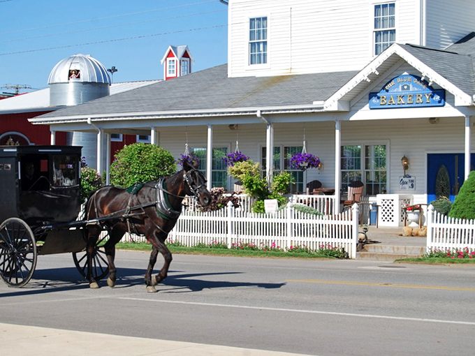 Where time slows down and taste buds perk up. A classic Amish bakery welcomes visitors while a horse-drawn buggy passes by&mdash;quintessential Shipshewana in one perfect frame.