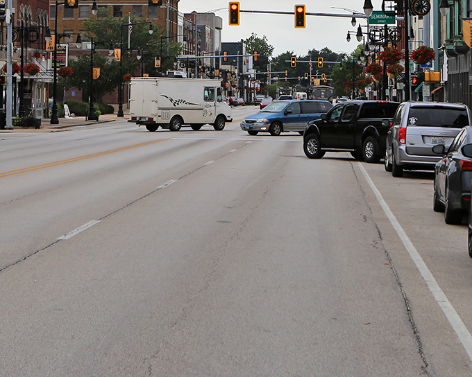 Downtown Galesburg's historic brick facades stand like sentinels of Midwestern prosperity, where orange construction cones are the only thing slowing down the relaxed pace of life.