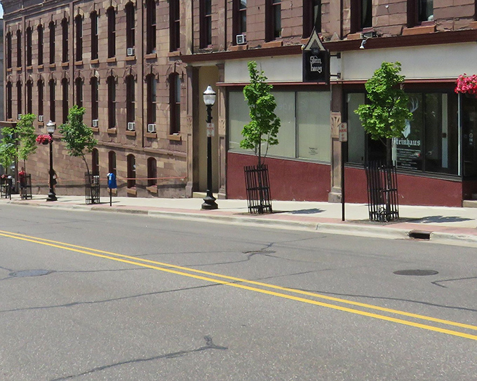Historic sandstone buildings line downtown Marquette, where century-old architecture meets modern small businesses in a perfect blend of past and present.